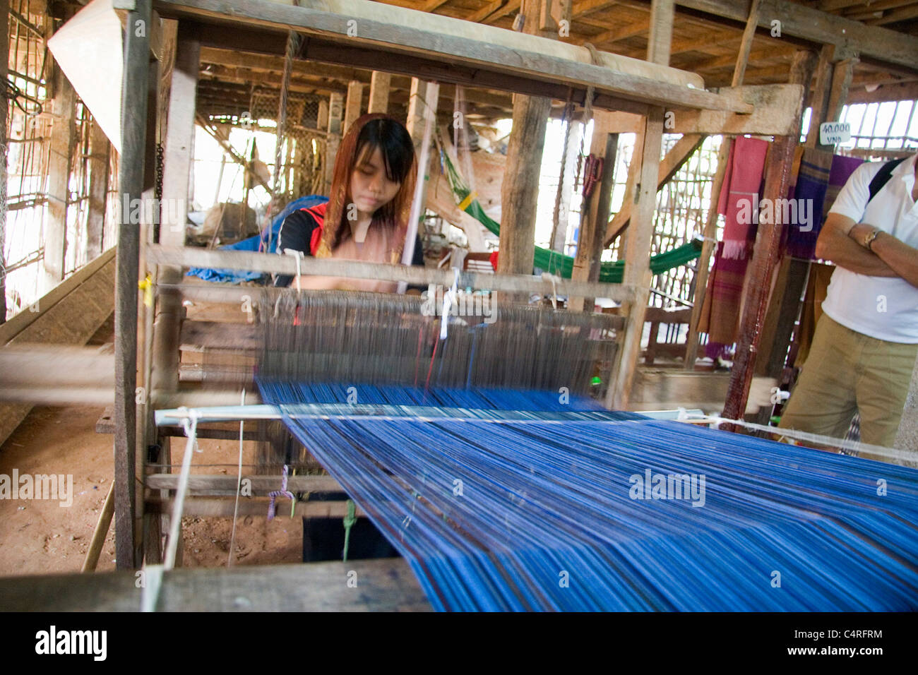 A young girl at work weaving on a loom, Cambodia Stock Photo - Alamy