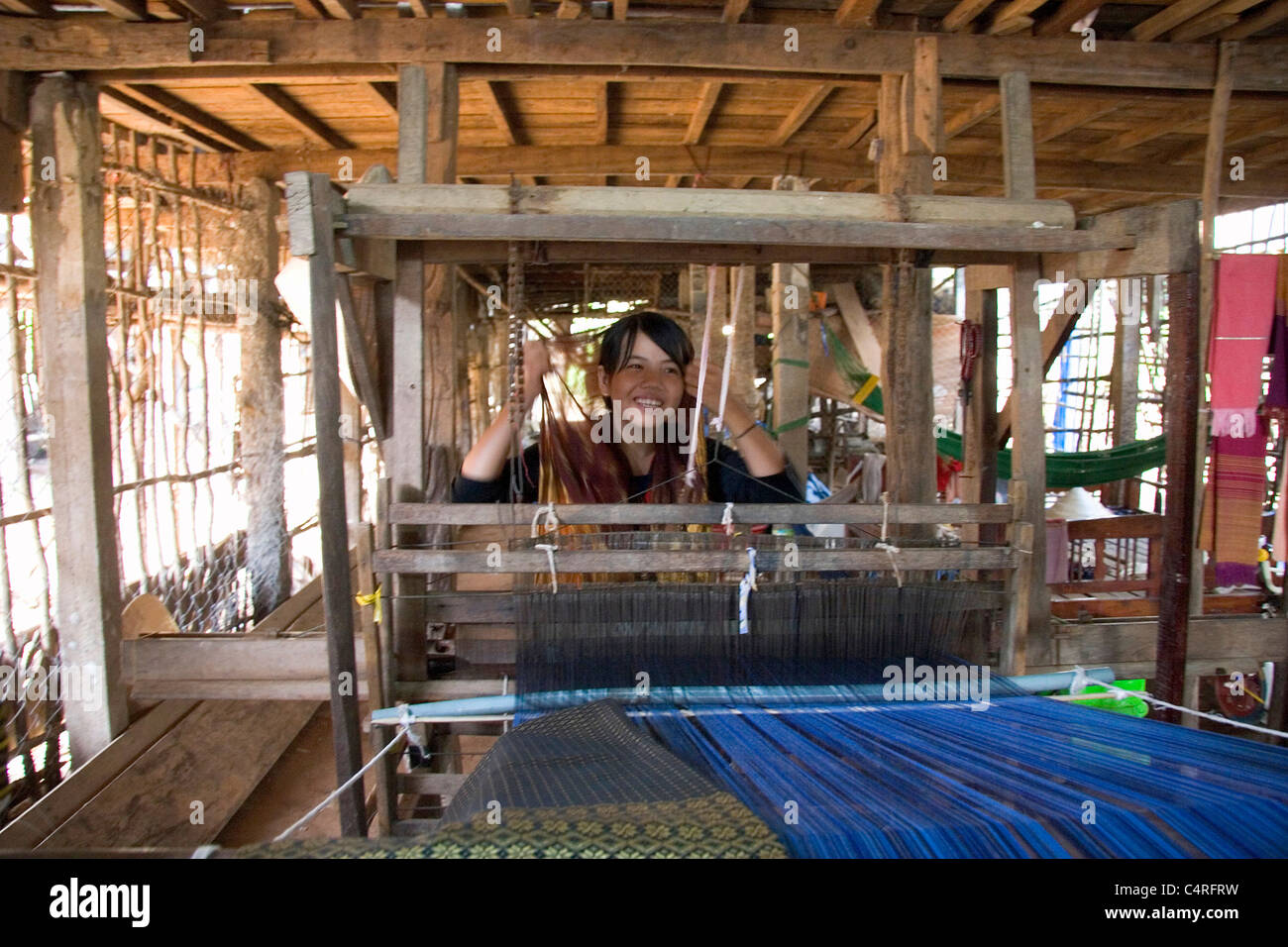 A young girl at work weaving on a loom, Cambodia Stock Photo - Alamy