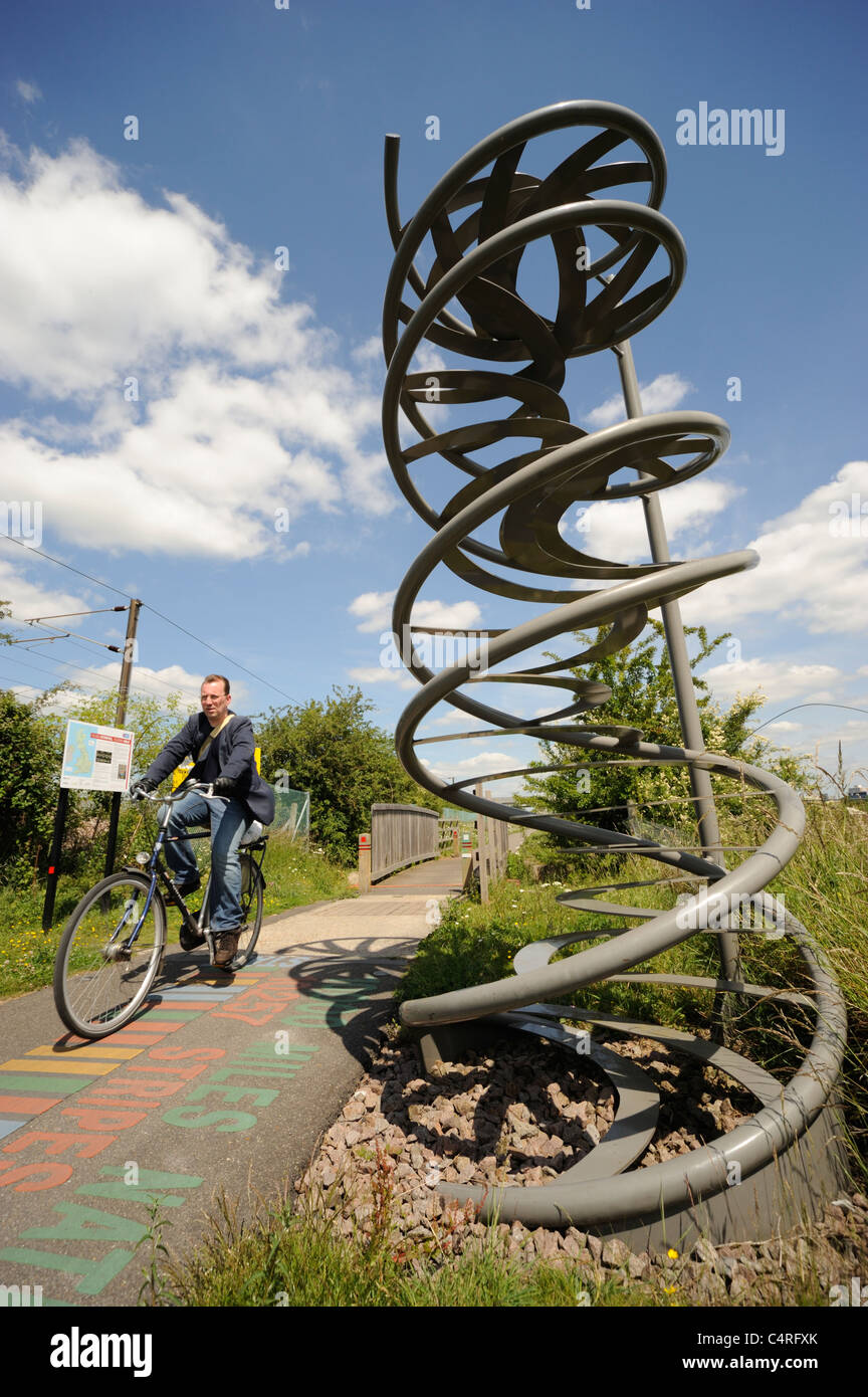 cyclist passing DNA sculpture on cycle path Cambridge Stock Photo - Alamy