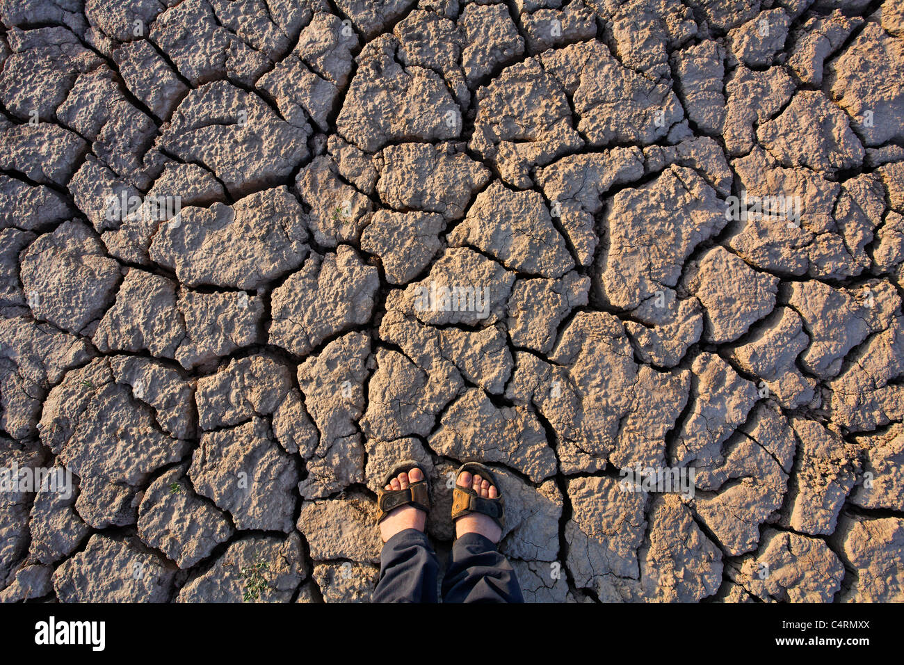 Kyrgyzstan - Toktogul - sandled feet and dried earth at Toktogul ...