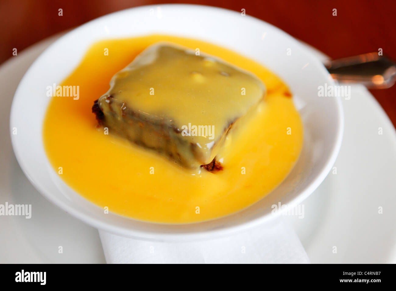 Sticky Toffee Pudding is served with Custard Stock Photo - Alamy