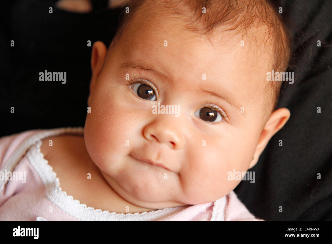 Baby looking at camera Stock Photo - Alamy