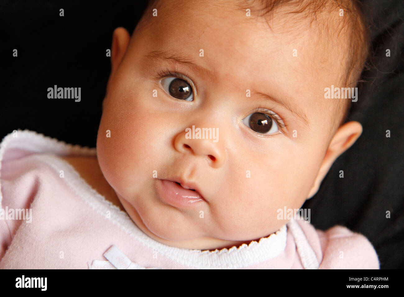 Baby looking at camera Stock Photo - Alamy