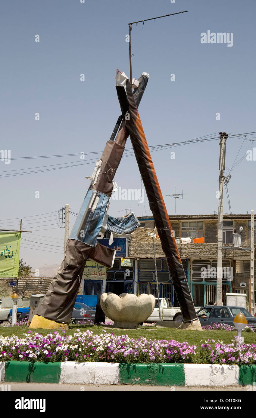 Monument with AK-47 and pencil in Shirvan, North Khorasan province ...
