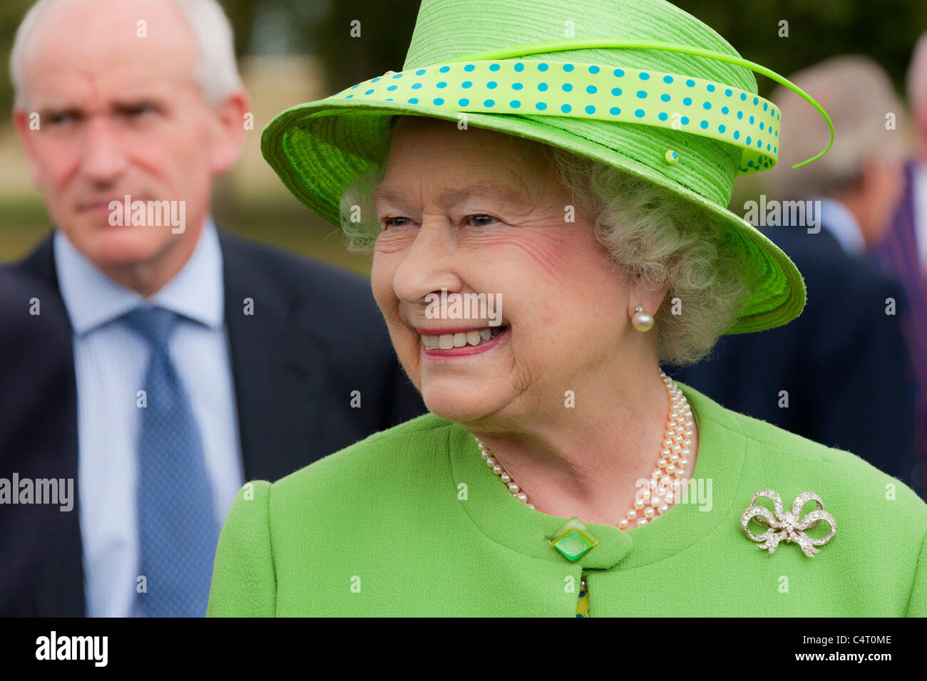 Her Majesty Queen Elizabeth II smiling dressed in green hat and coat ...