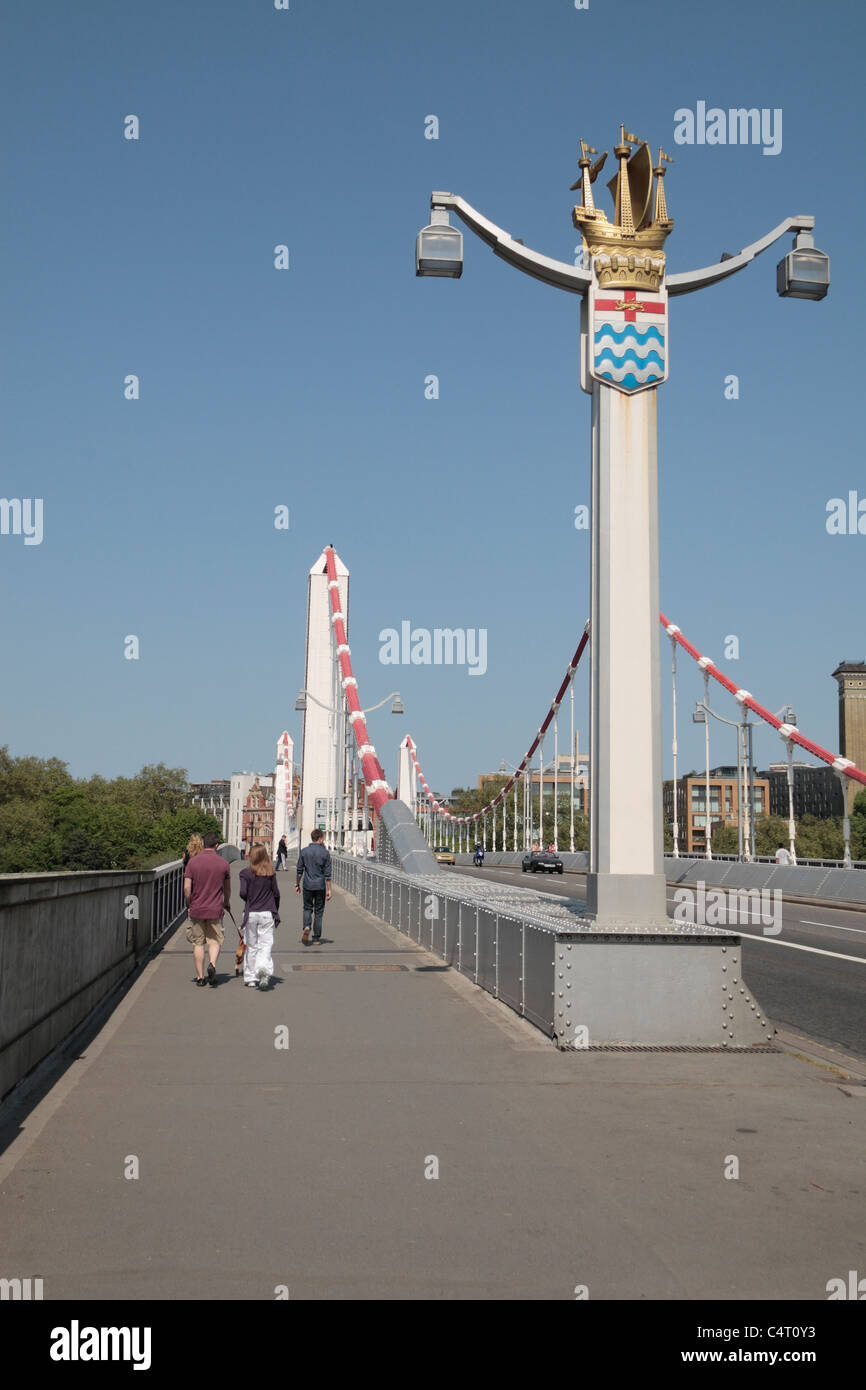 People walking across Chelsea Bridge, near Battersea Park, London, UK ...