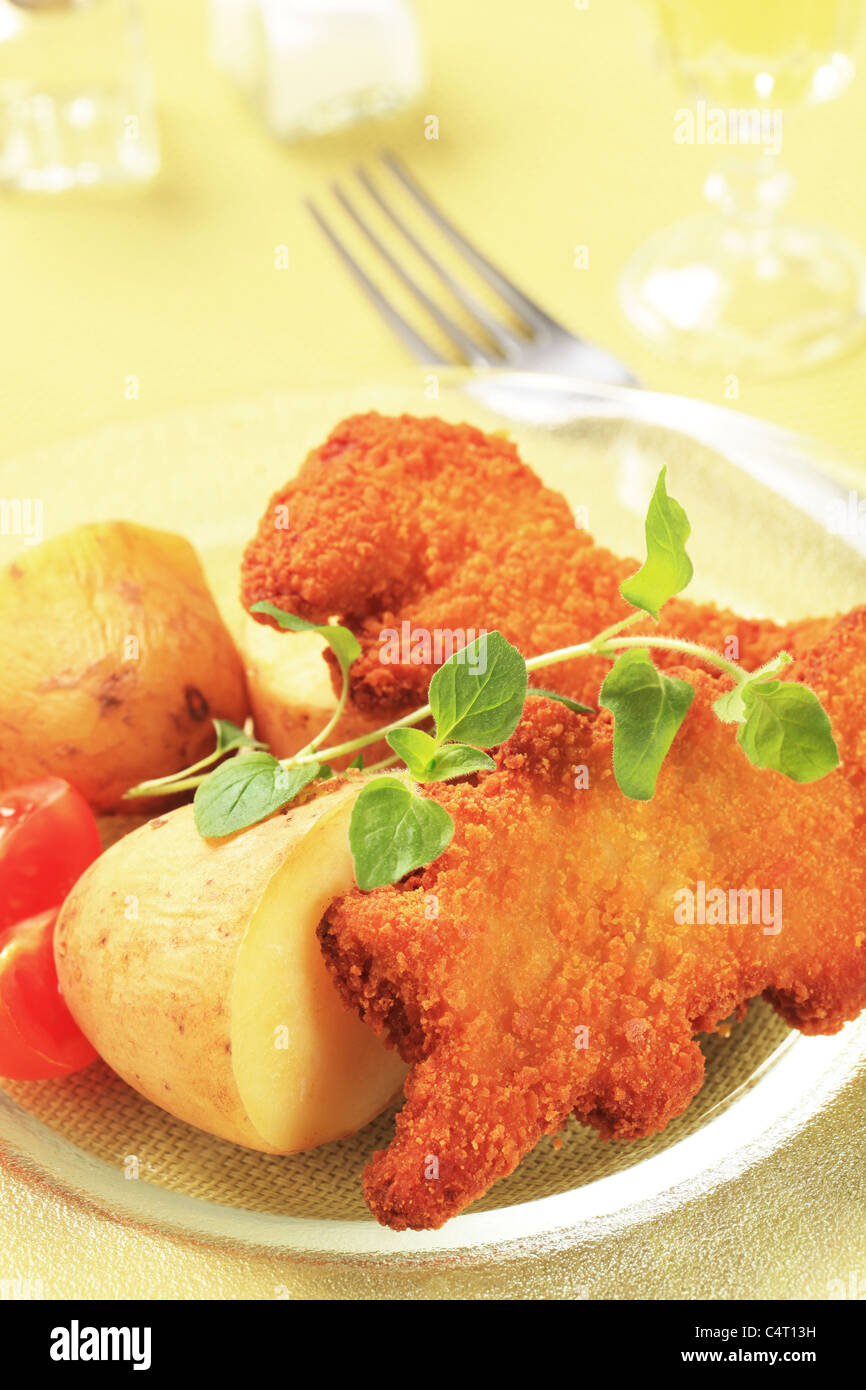 Dinosaurs shaped fried fish and potatoes - closeup Stock Photo - Alamy