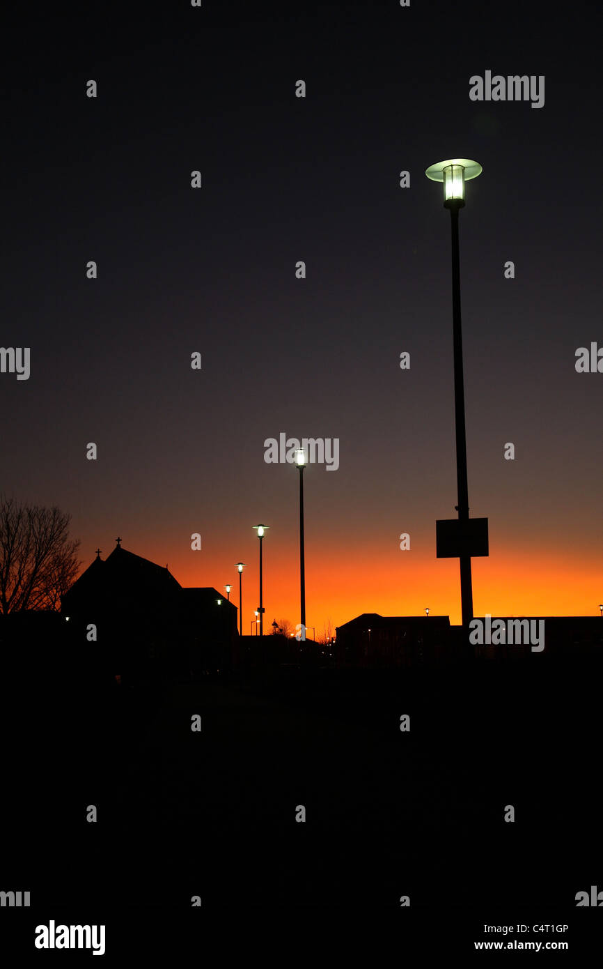 Sunset with street lights in an urban setting Stock Photo - Alamy