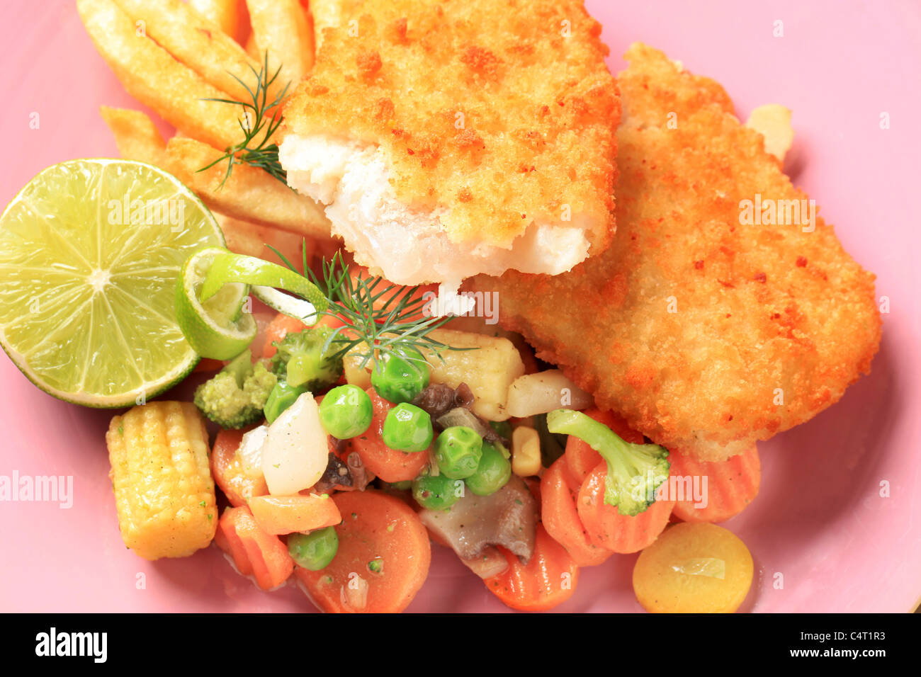 Fried fish served with French fries and mixed vegetables Stock Photo ...