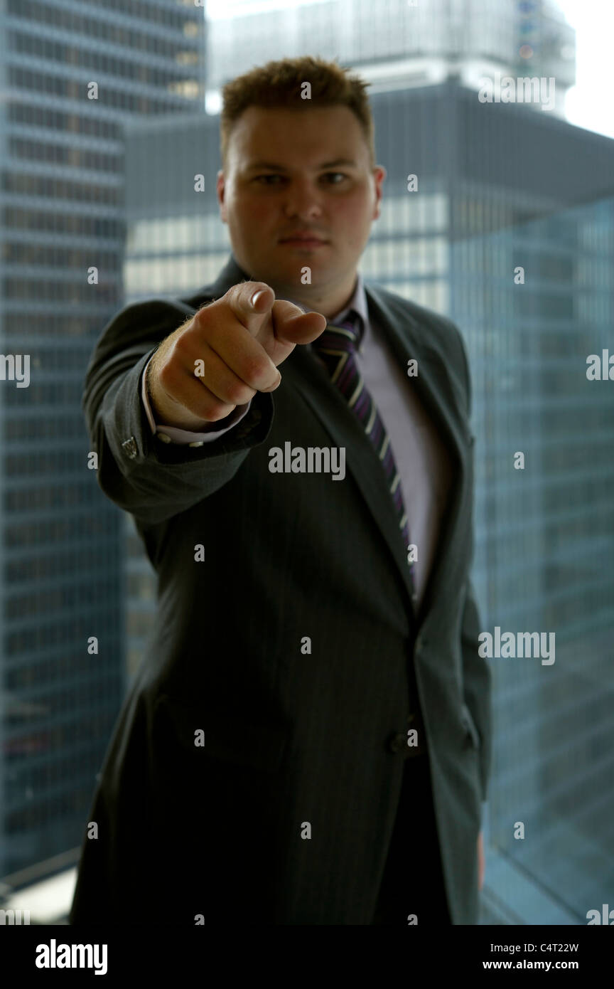 Young man in formal attire pointing finger Stock Photo - Alamy