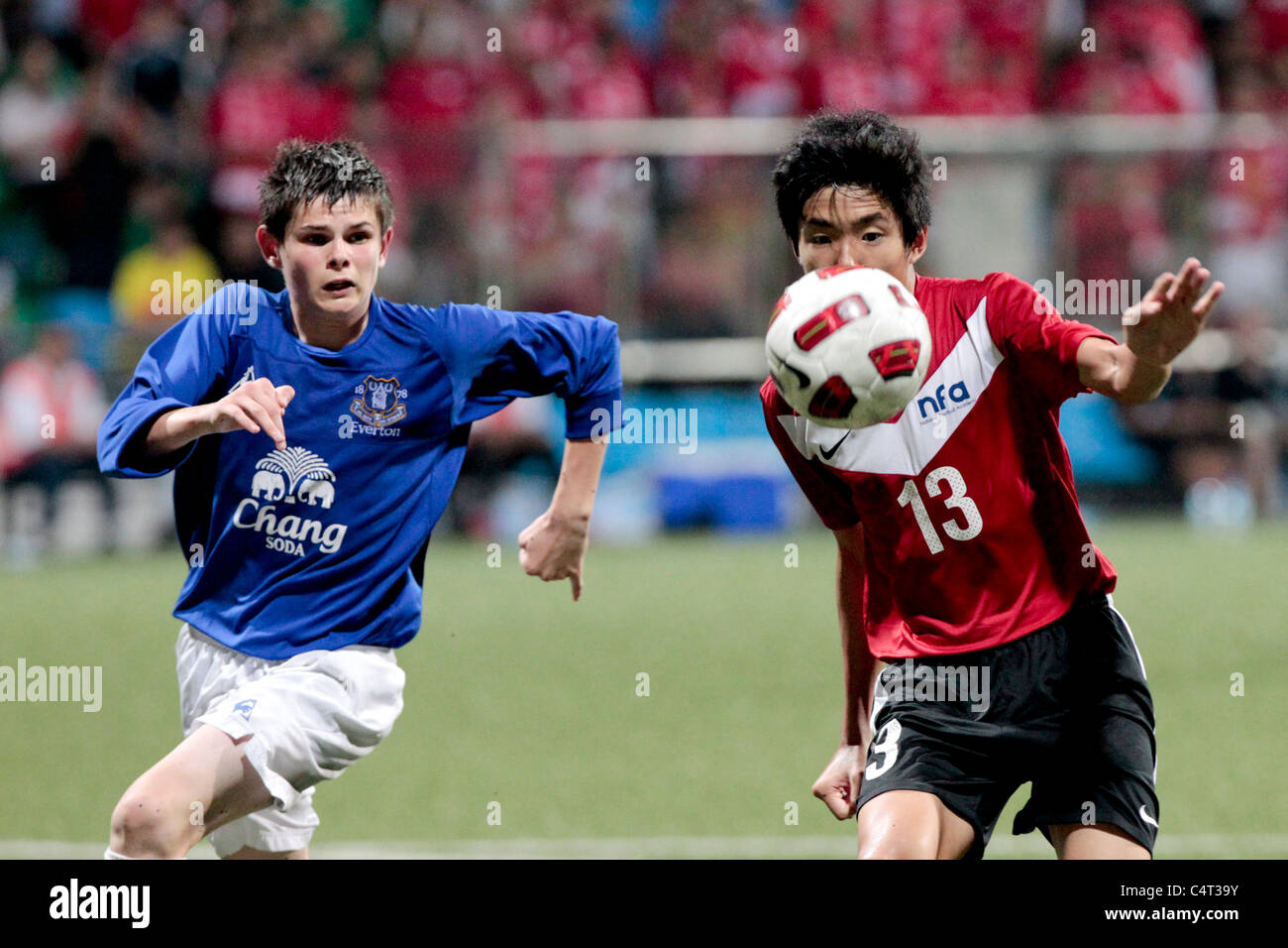 Hazim Hassan of Singapore U16(red) and James Graham chase down the ...