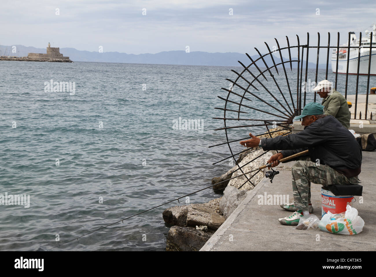 Greek men fishing at the seaside in Rhodes, Greece Stock Photo - Alamy
