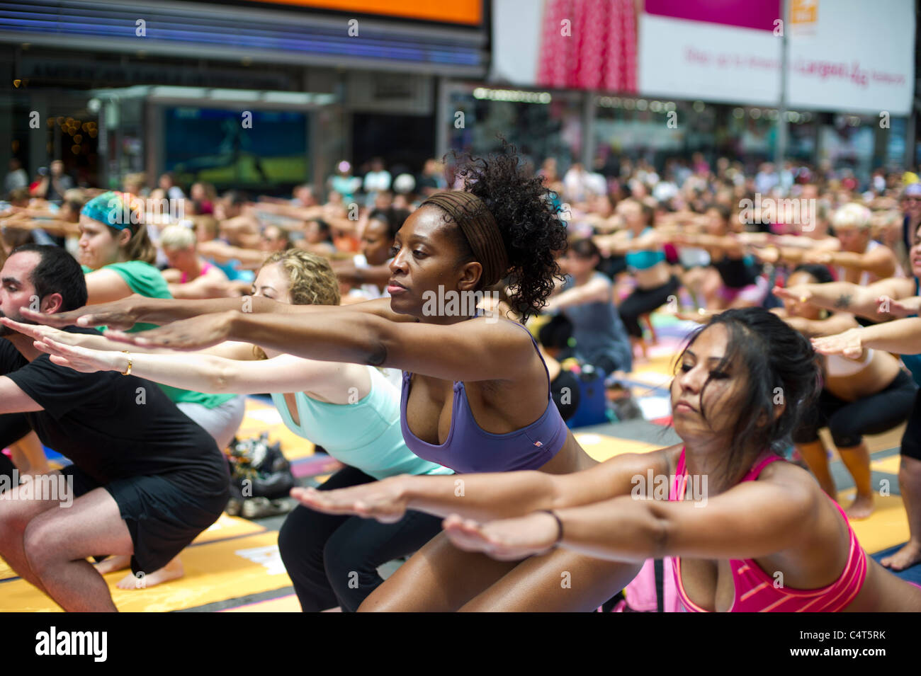 Thousands of yoga practitioners in Times Square in New York participate ...