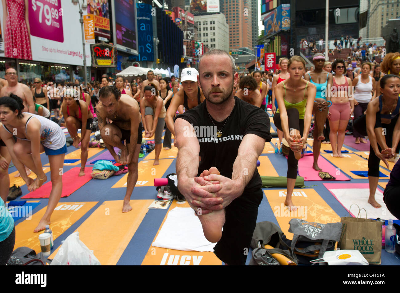 Thousands of yoga practitioners in Times Square in New York participate ...