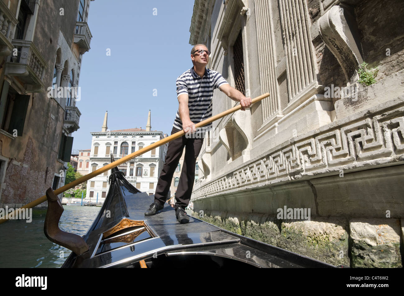 Gondola boatman rowing down canal, Venice, Italy Stock Photo - Alamy