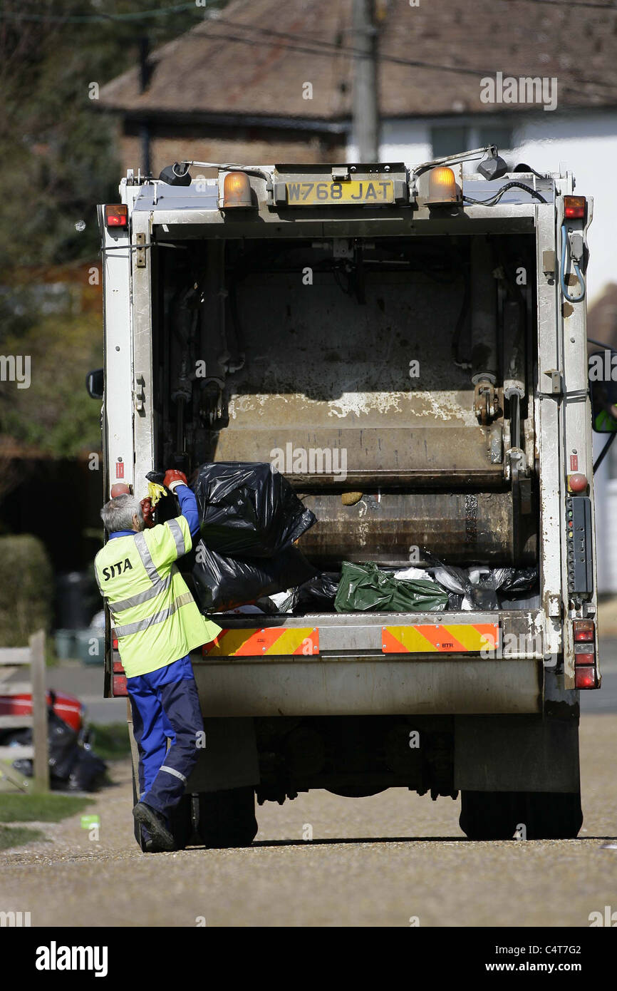 Dustmen collecting rubbish on a residential street in Britain. Picture ...