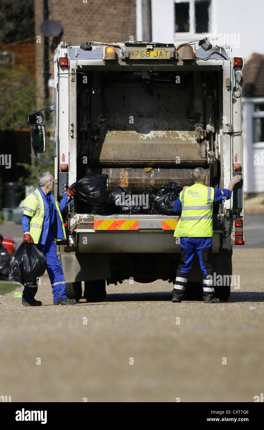 Dustmen collecting rubbish on a residential street in Britain. Picture ...