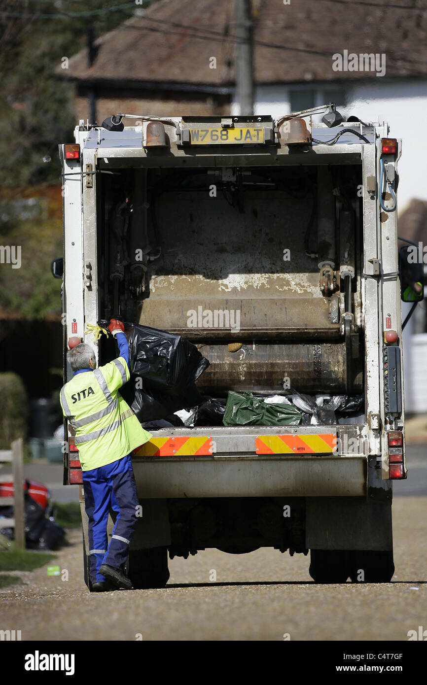 Dustmen collecting rubbish on a residential street in Britain. Picture ...