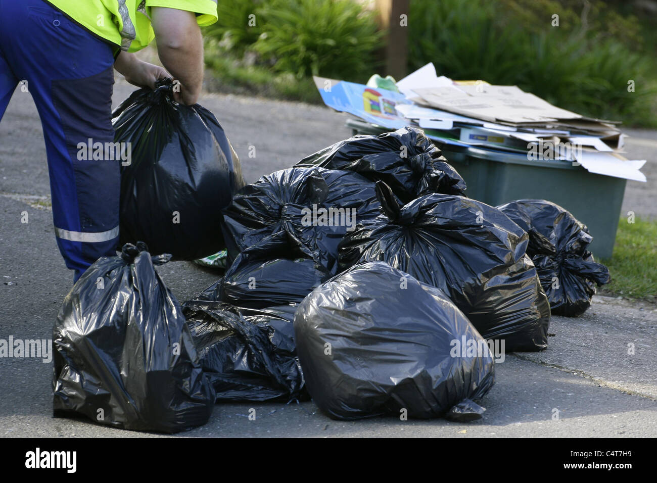 Dustmen collecting rubbish on a residential street in Britain. Picture ...