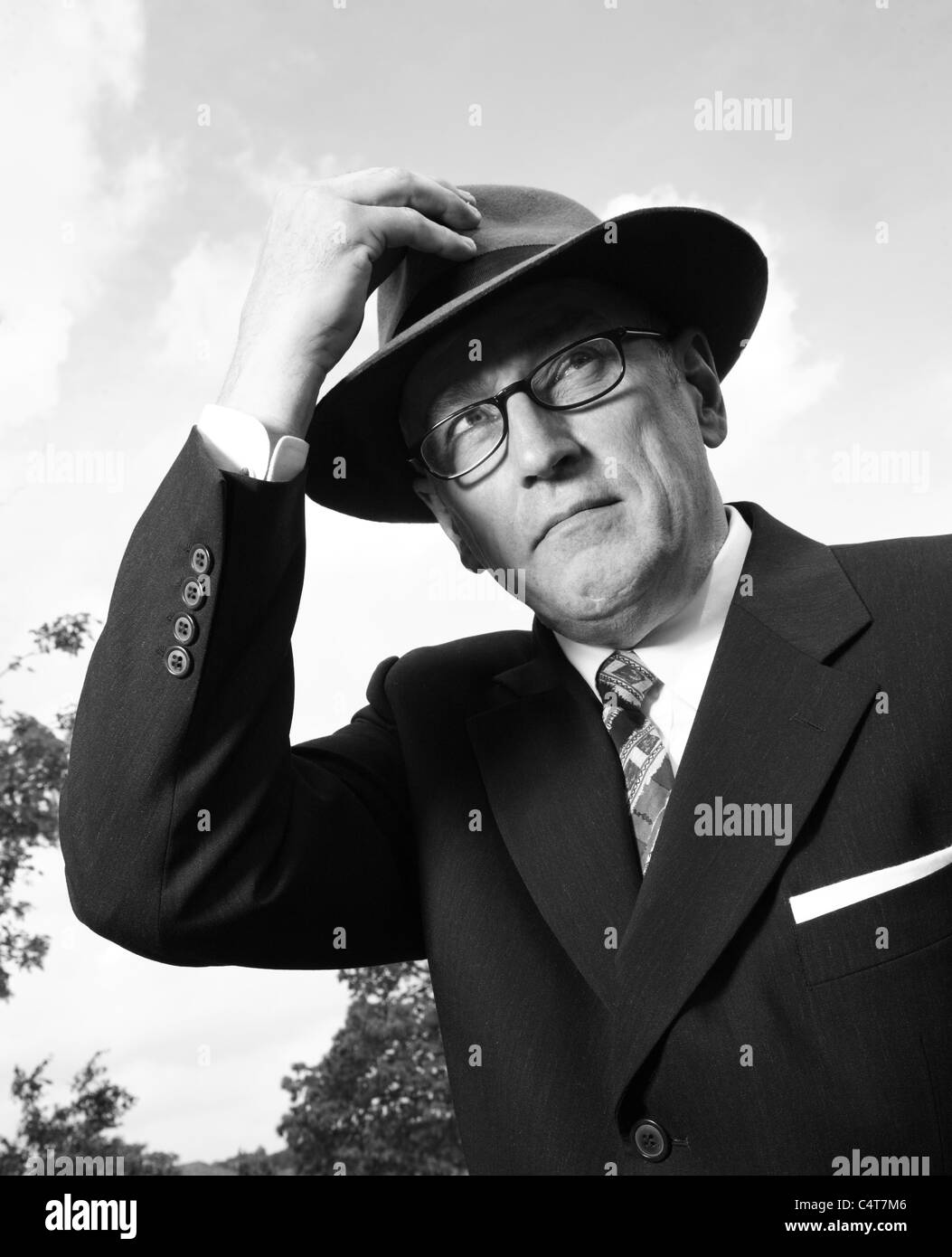 Old fashioned 1940-1950s gentleman wearing a Trilby or Fedora hat and ...