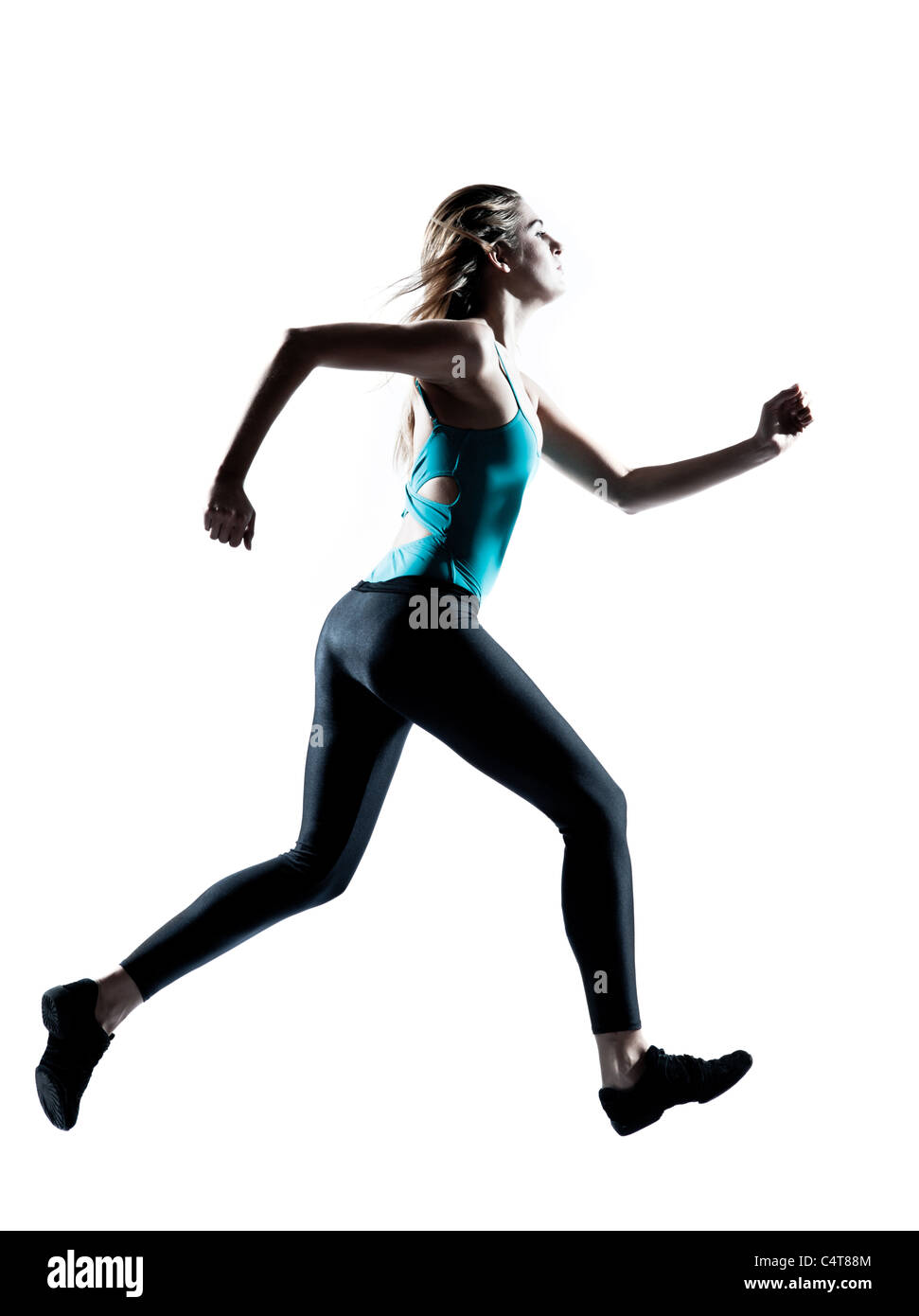 Side view of a young sporty woman jogging isolated on white background ...