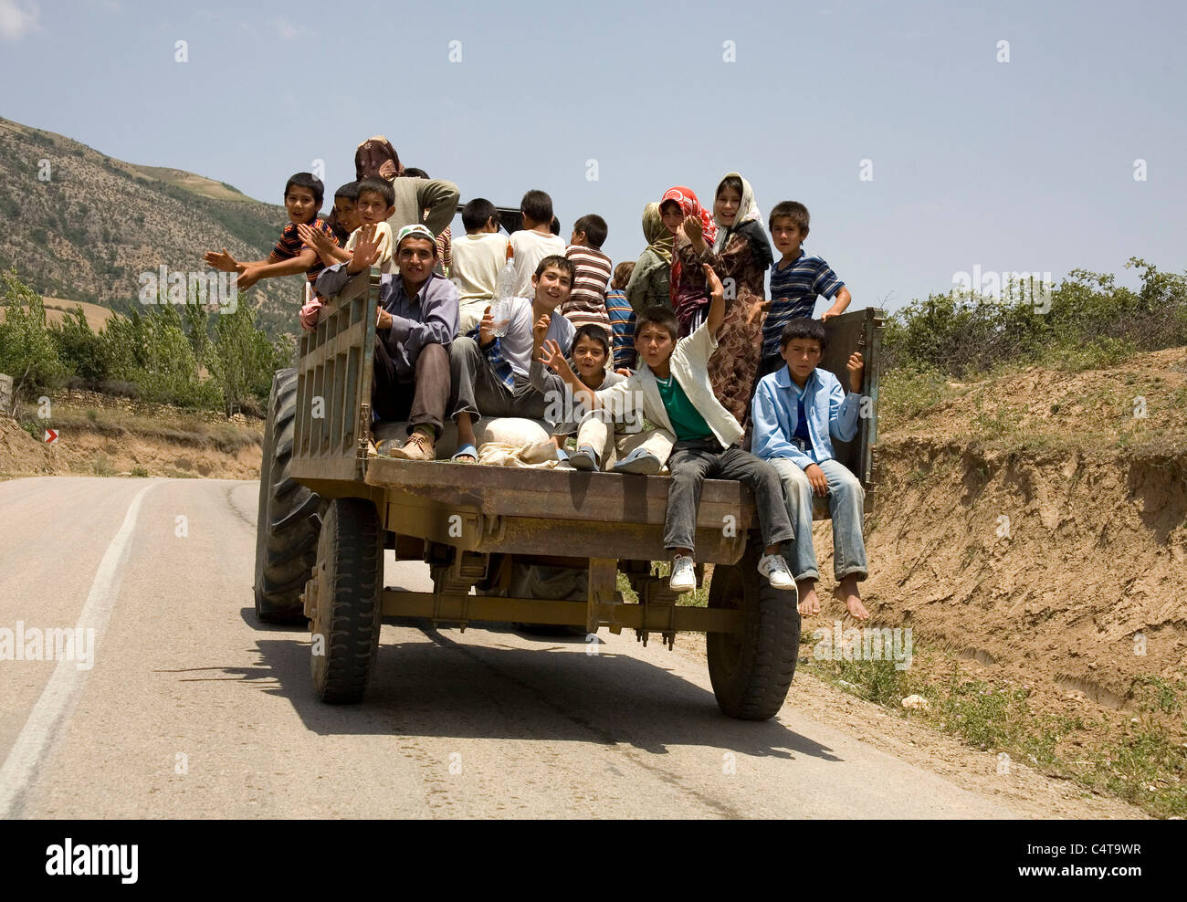 People riding a tractor in northeastern Iran Stock Photo - Alamy