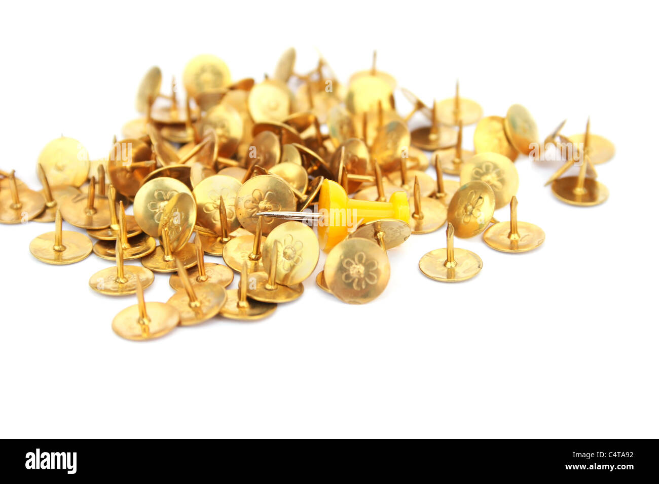 Yellow office pins isolated on white background Stock Photo - Alamy