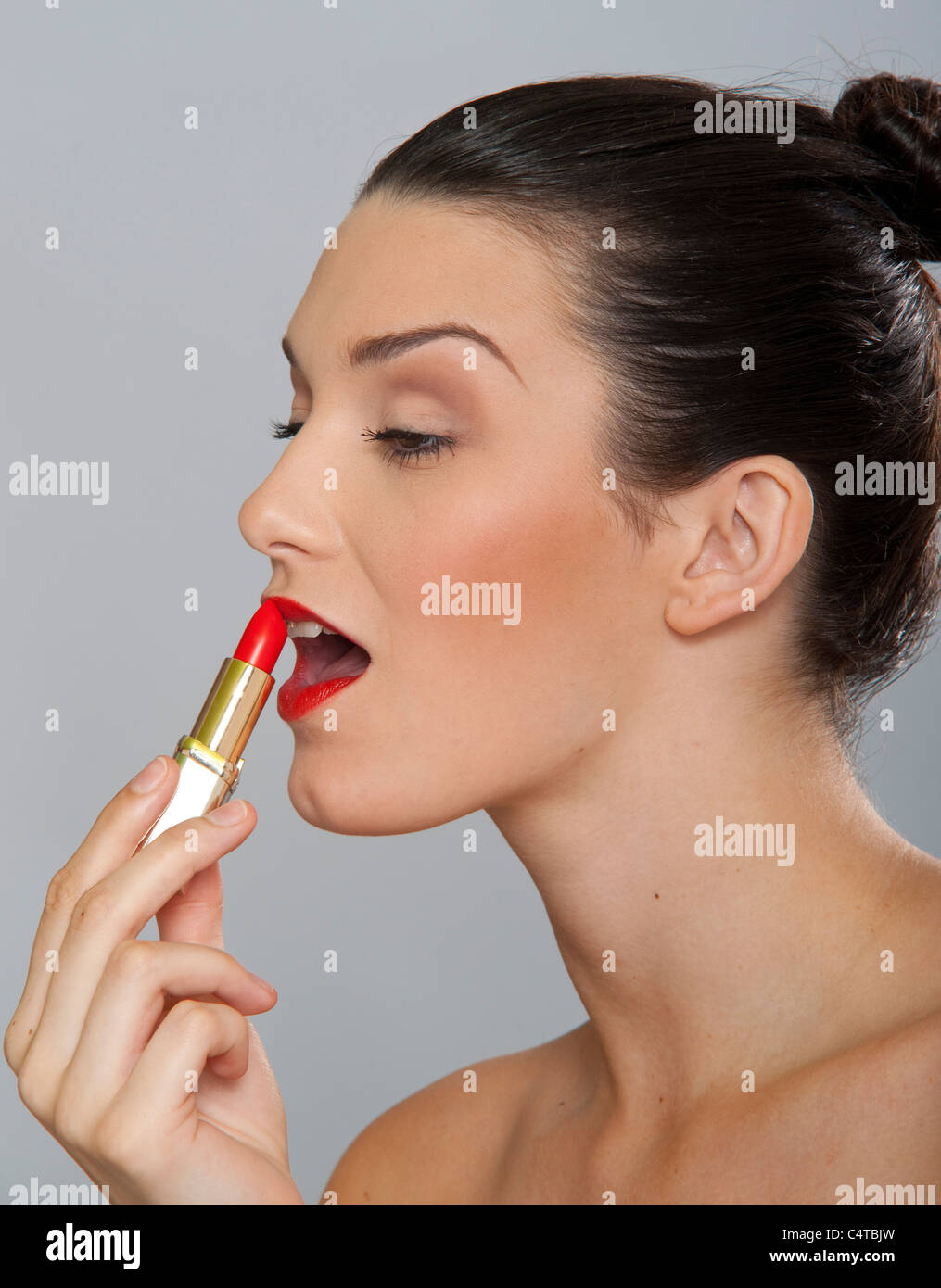 Woman Applying Lipstick Stock Photo - Alamy