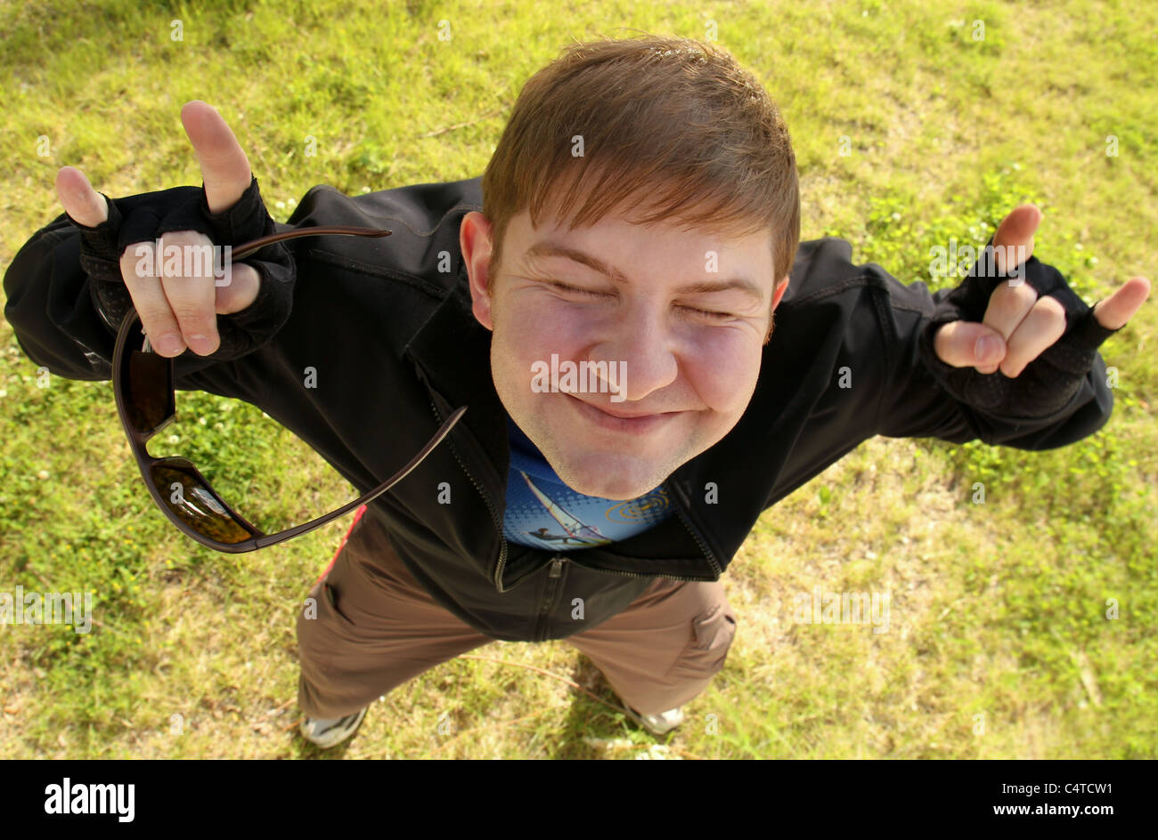 Funny man showing heavy metal sign Stock Photo - Alamy