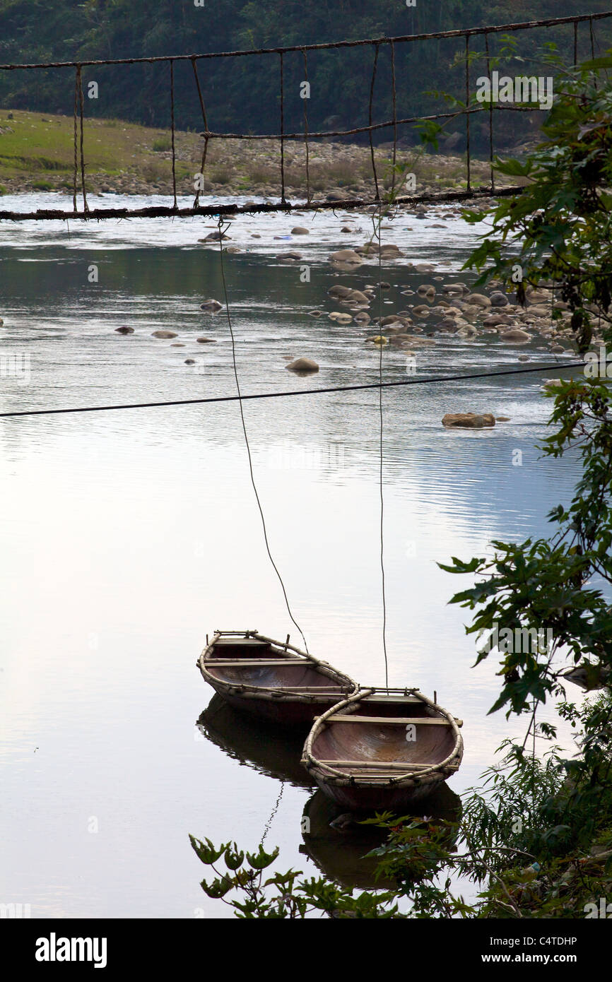 Two boats tied to old bridge Stock Photo - Alamy