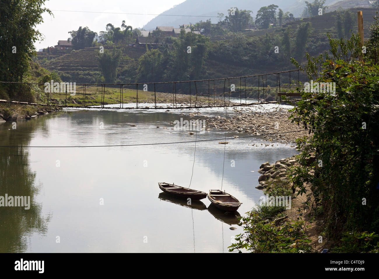 Two boats tied to old bridge Stock Photo - Alamy