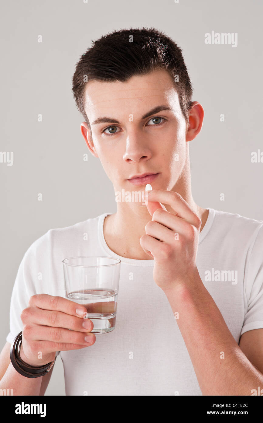 Yougn Man Taking Pill Stock Photo - Alamy