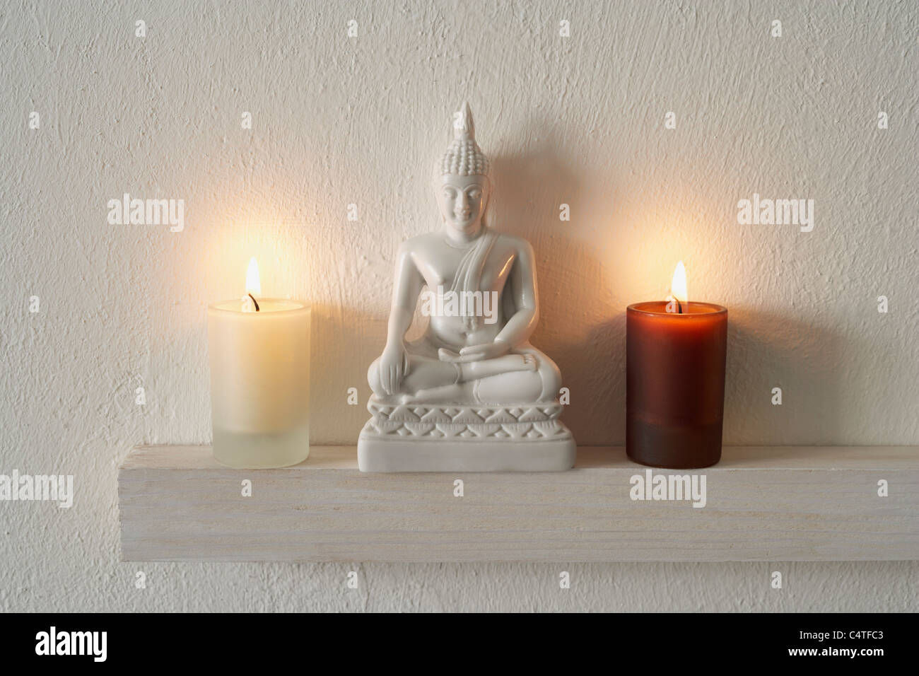 Buddha Statue and Candles Stock Photo - Alamy