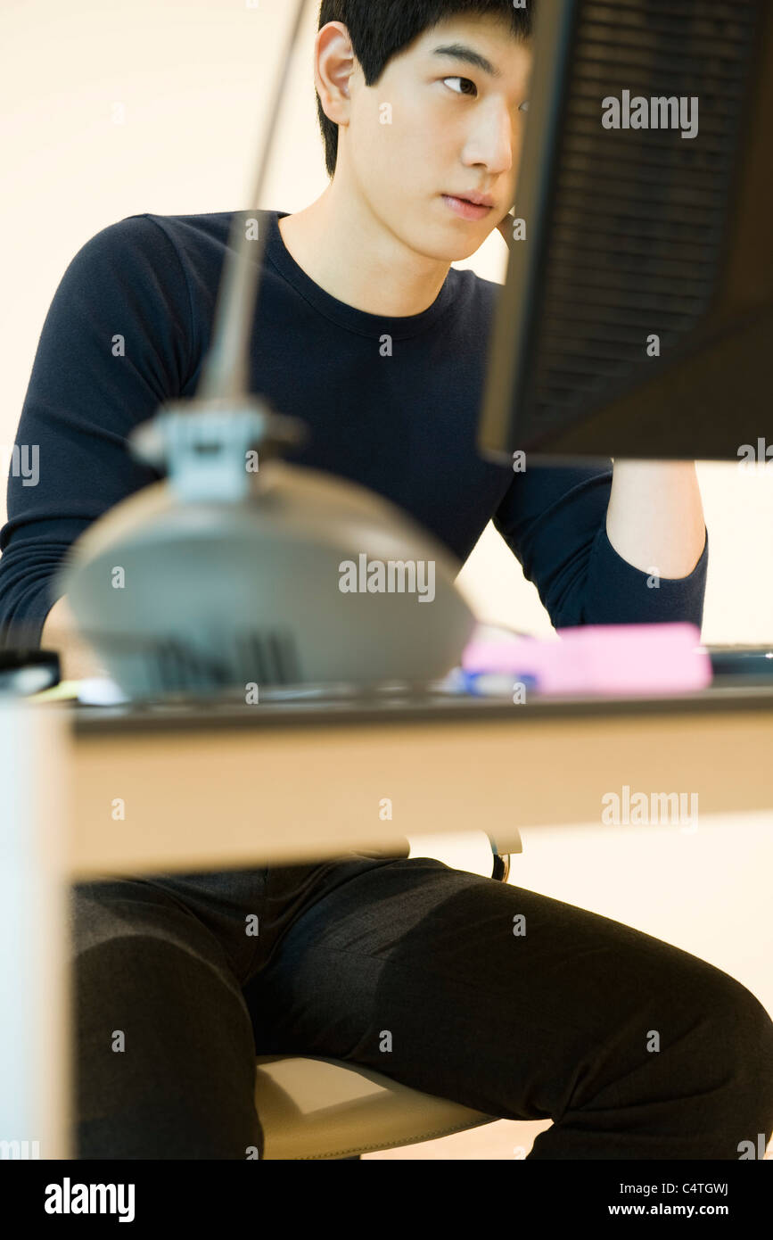 Young man working at desk Stock Photo - Alamy