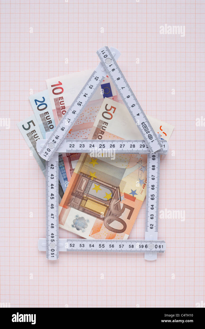 House Made of Expandable Ruler and Euros on Graph Paper Stock Photo - Alamy