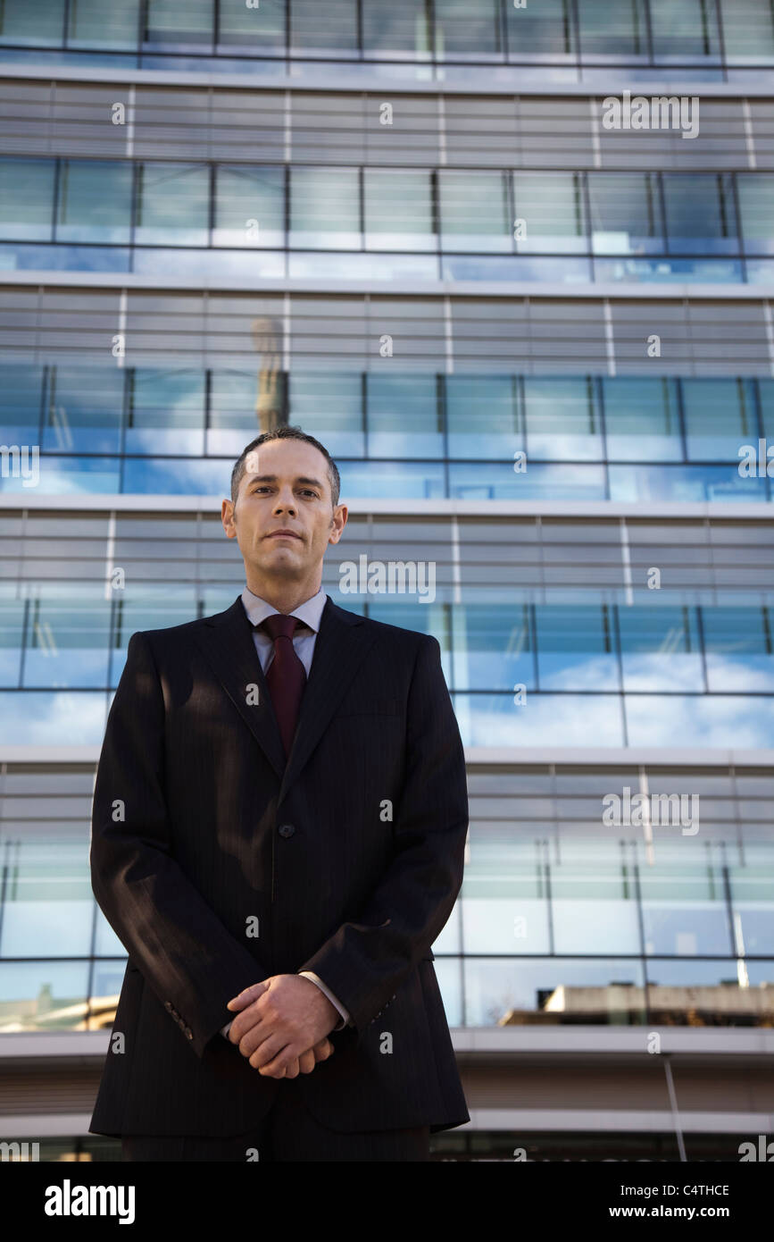 Executive standing in front building, portrait Stock Photo - Alamy