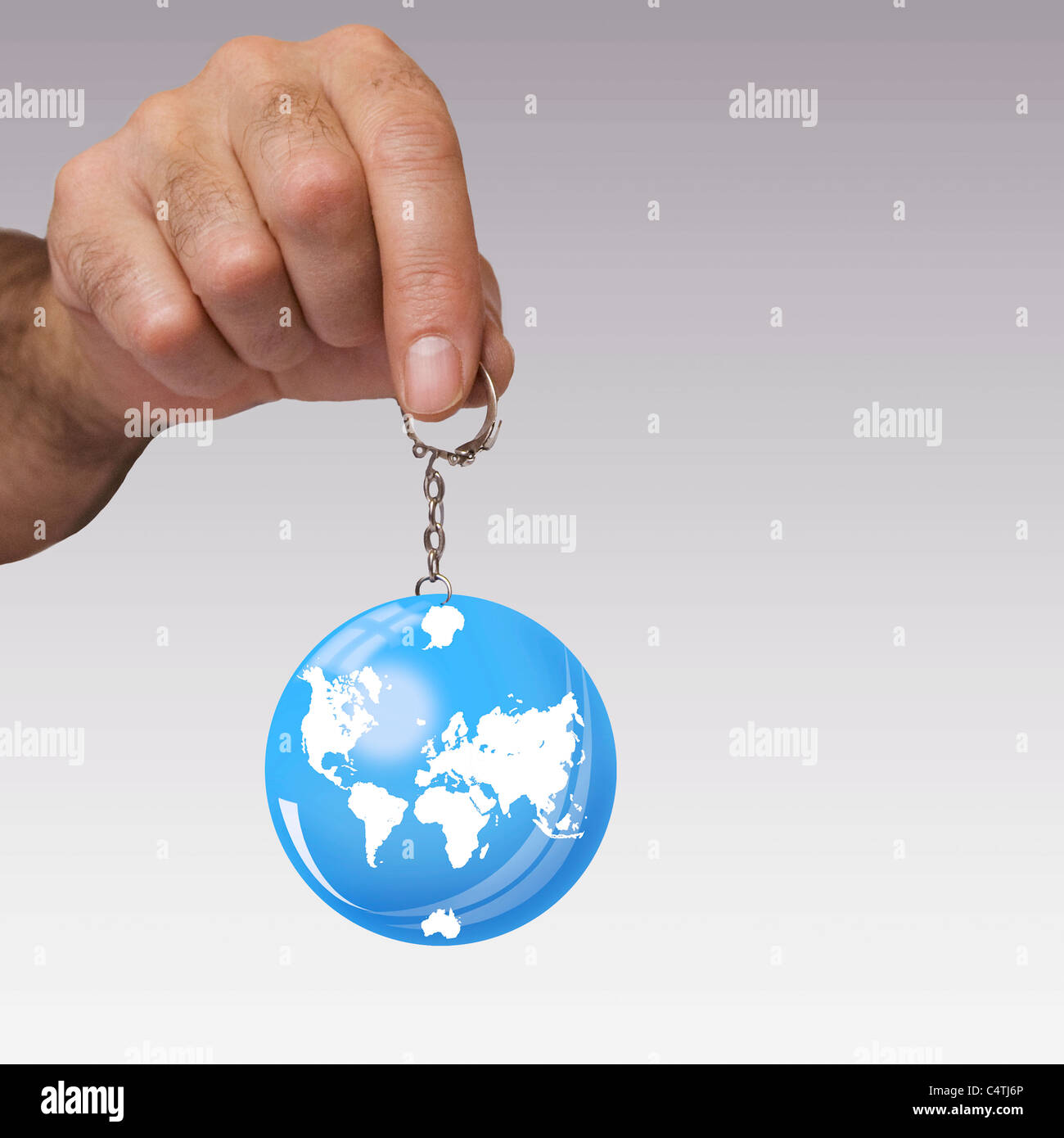 Hand holding planet earth key ring Stock Photo - Alamy