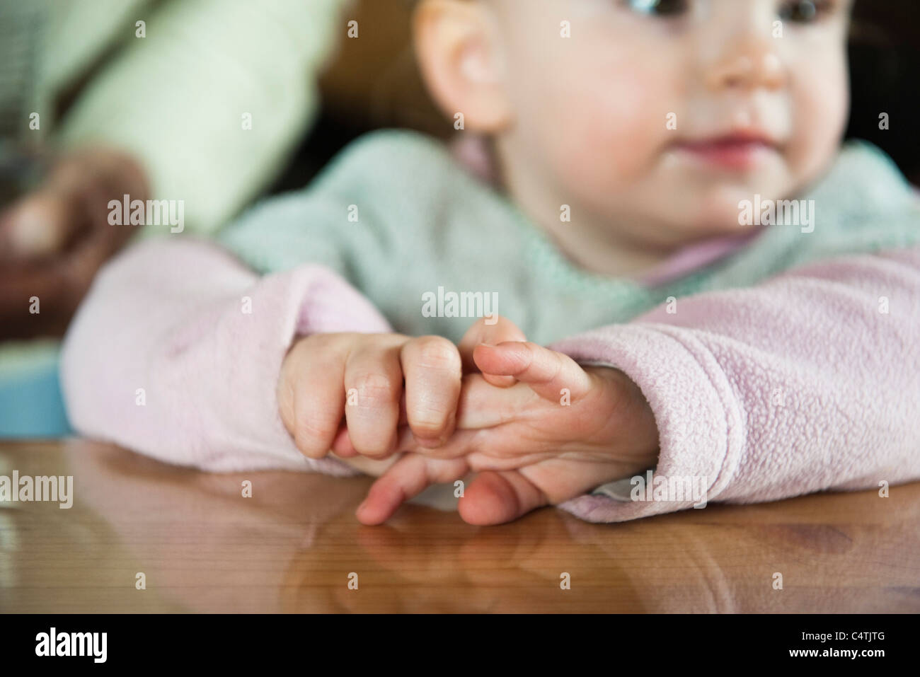 Baby girl's clasped hands Stock Photo - Alamy