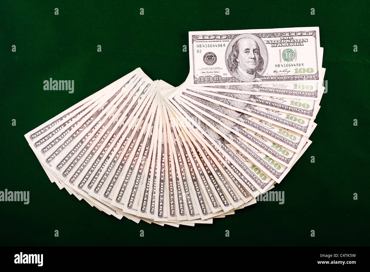 A combination of dollar fan over a green background Stock Photo - Alamy