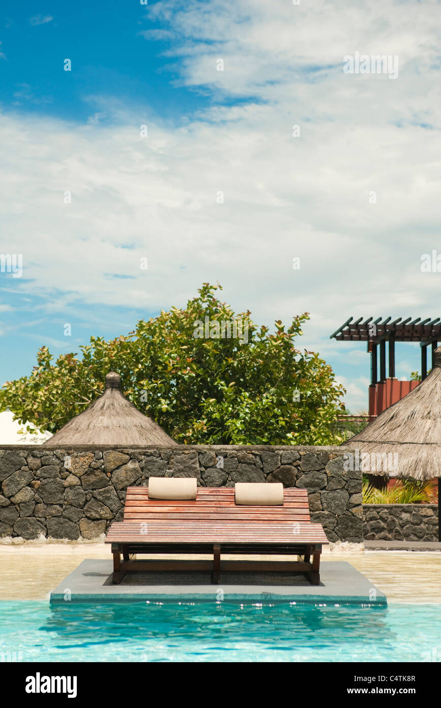Lounge chairs in resort swimming pool Stock Photo - Alamy
