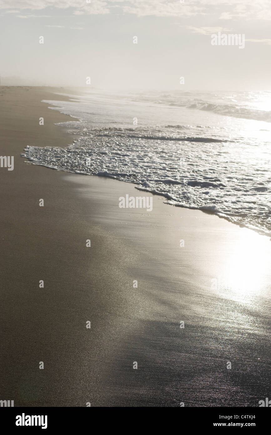Surf lapping beach Stock Photo - Alamy