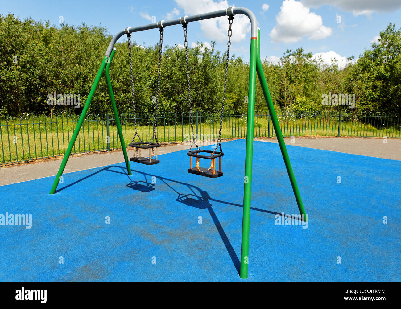 Empty swing on playground Stock Photo - Alamy