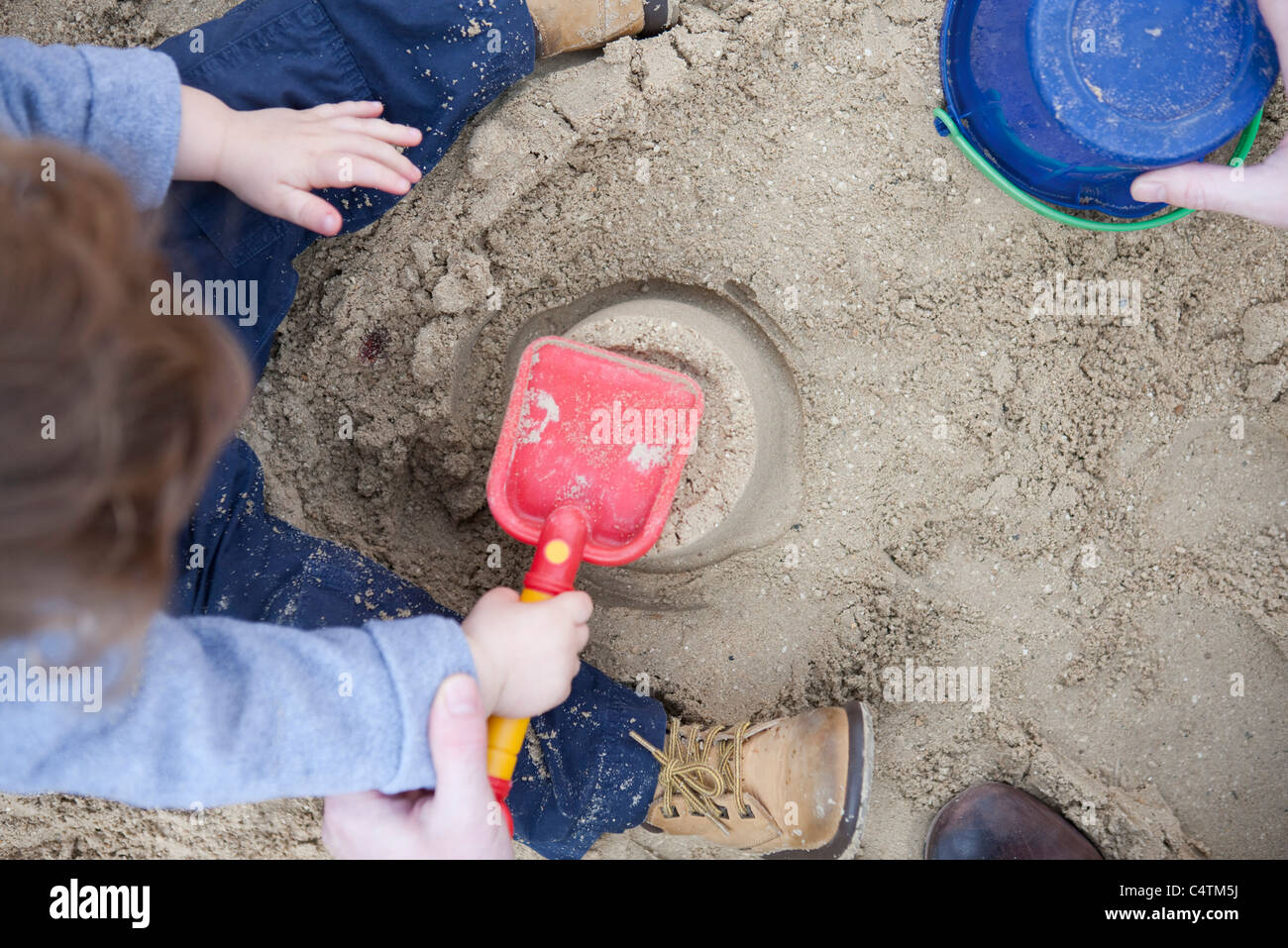 Toddler boy playing in sand Stock Photo - Alamy