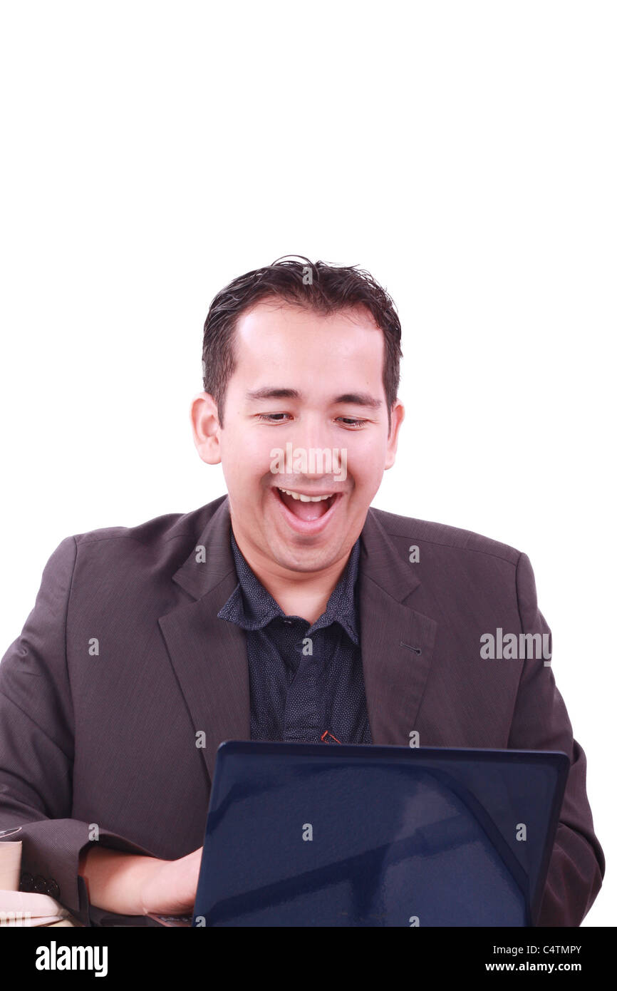 Happy young man working on laptop computer, having fun Stock Photo - Alamy