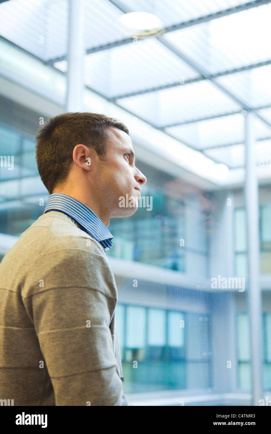Man looking through window, portrait Stock Photo - Alamy