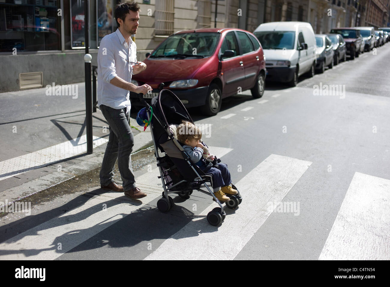 Father pushing toddler son in stroller Stock Photo - Alamy