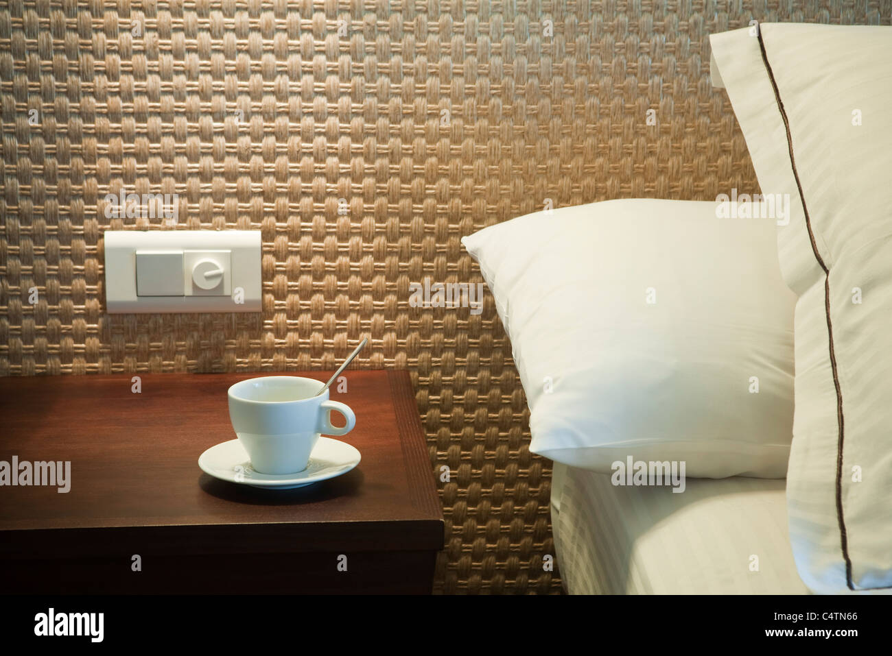 Coffee cup on bedside table Stock Photo - Alamy