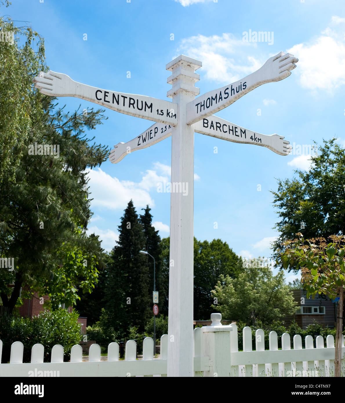 Direction sign with hands pointing in four directions Stock Photo - Alamy