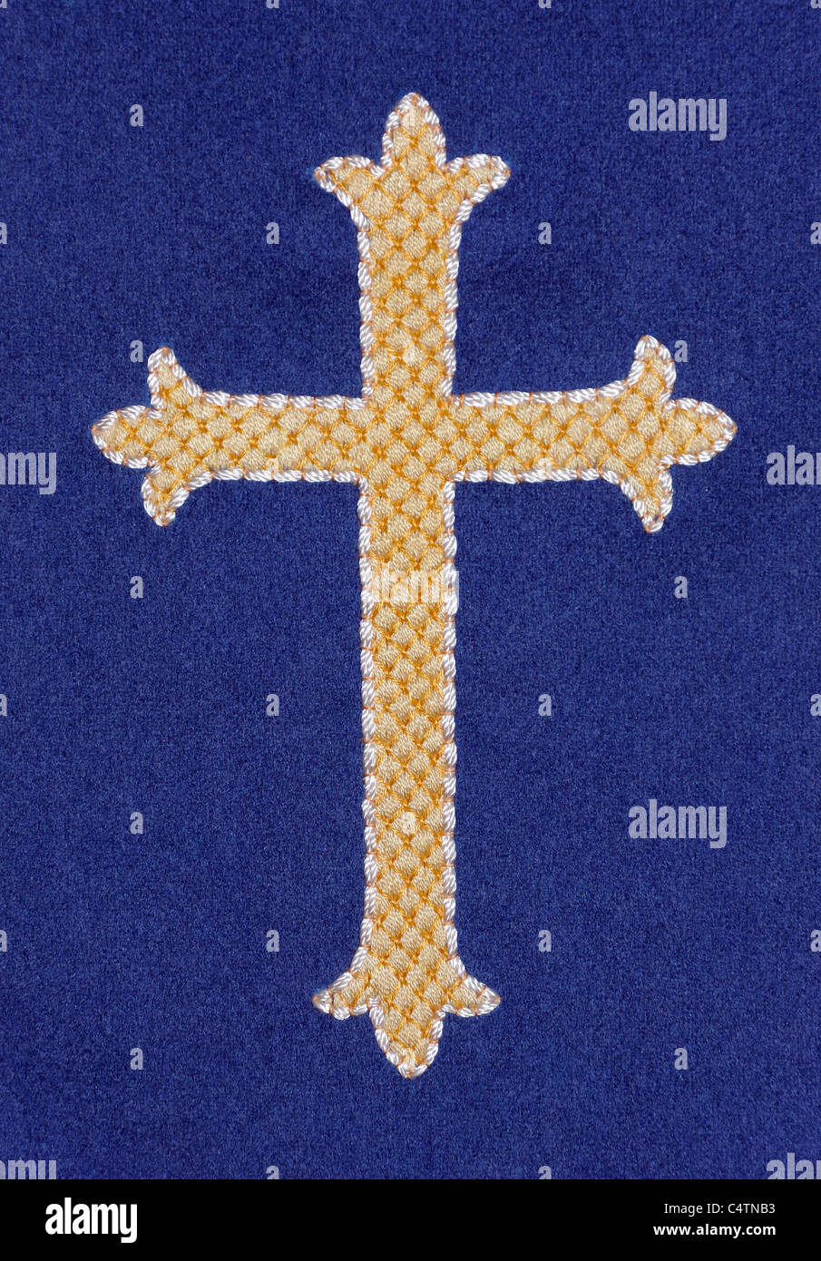 Detailed photograph of an embroidered gold cross on blue velvet Stock ...