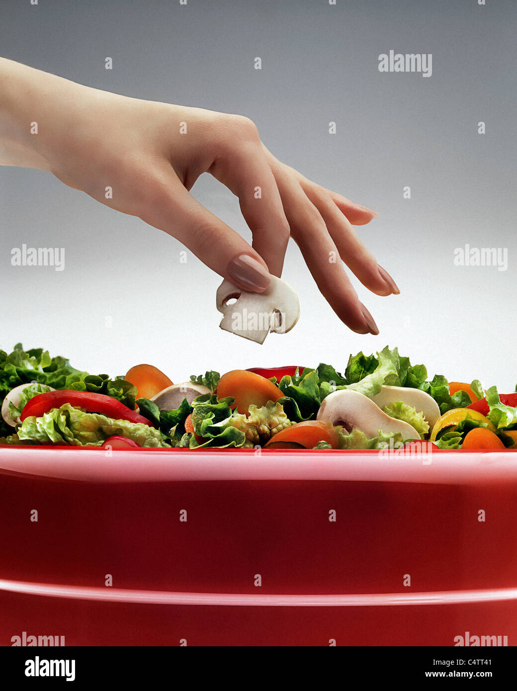 HAND ON VEGETABLE DISH Stock Photo - Alamy